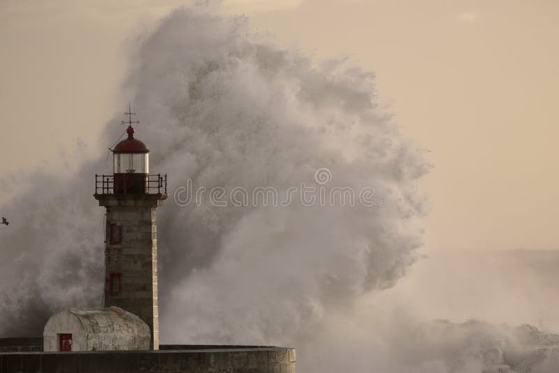 Wave Splash Over Lighthouse at Sunset Stock Photo - Image of rough ...