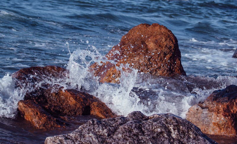 Wave splash on the rocks stock image. Image of beautiful - 137347761
