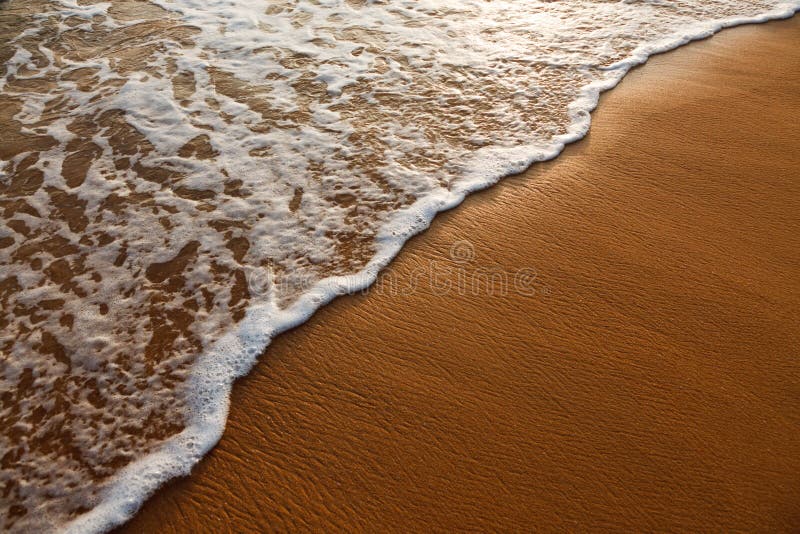 Wave surging on sand stock photo. Image of oceanic, sand - 17068280