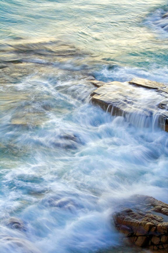 Wave washing on rocks stock image. Image of pure, cleansing - 5559565