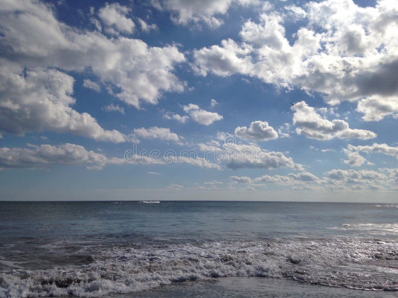 Waves along the shore stock photo. Image of skies, clouds - 113771692