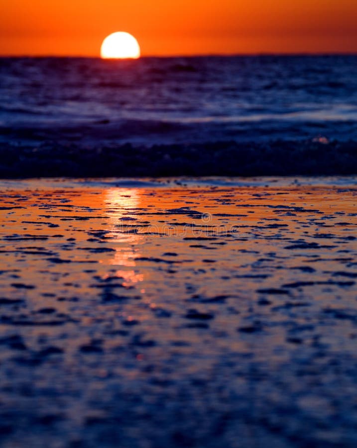 Waves on beach at sunset stock image. Image of waves - 57753215