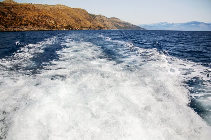 Waves behind boat underway stock image. Image of coast - 114798933