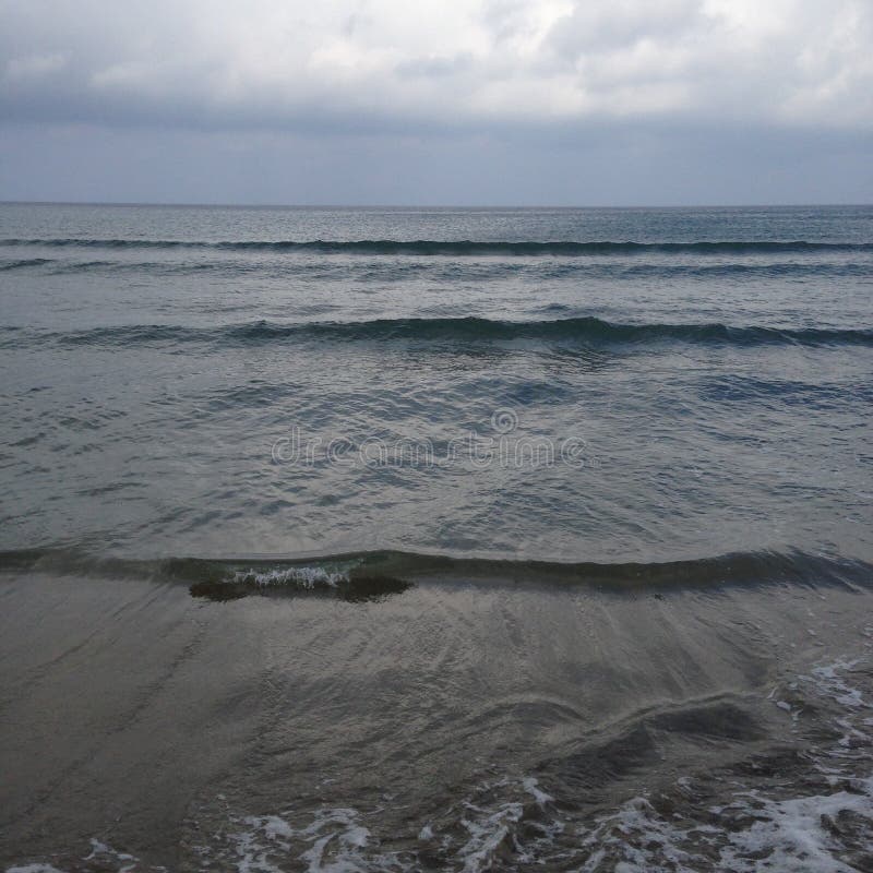 Waves breaking on a beach stock image. Image of receding - 49343835