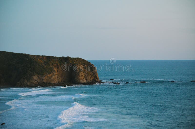 Waves Breaking at a Point Break Against Cliffside Stock Photo - Image ...