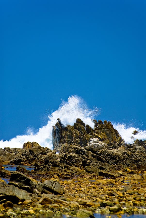 Waves breaking on rocks stock photo. Image of splashing - 3743166