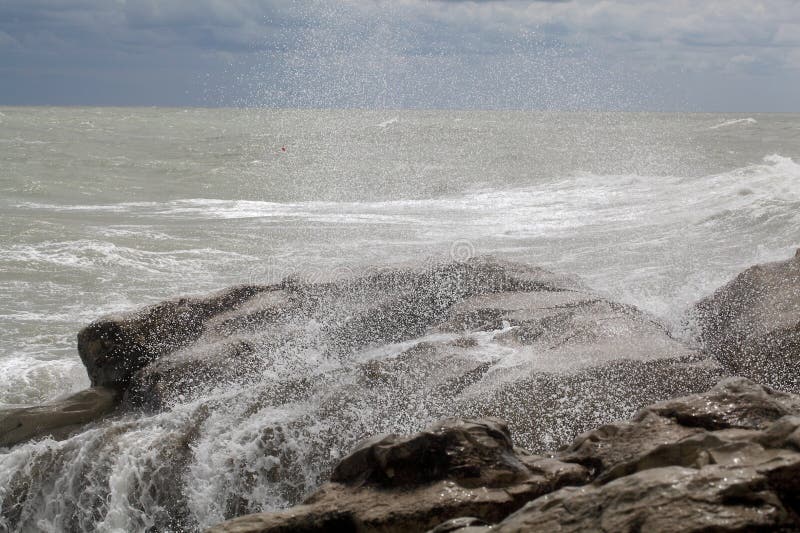 Waves breaking on rocks stock photo. Image of rocks, beach - 75164000