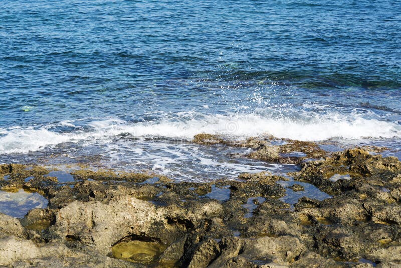 The Waves Breaking on a Stony Beach, Forming a Spray. Wave and Splashes ...