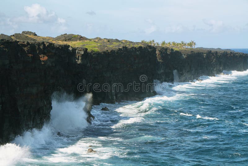 Waves Crash Along the Black Lava Rock Cliffs Stock Image - Image of ...