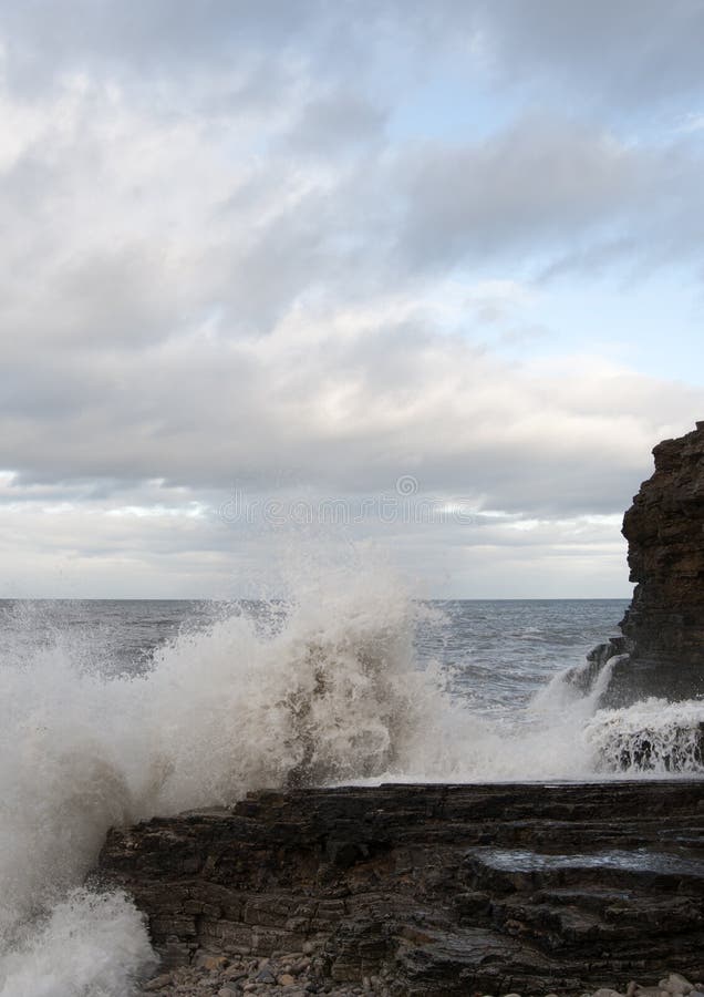 Waves Crash on the Rocks. stock photo. Image of high - 87978724