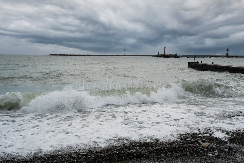 Waves Crash on Rocky Shore Under Cloudy Sky at Coastal Location during ...
