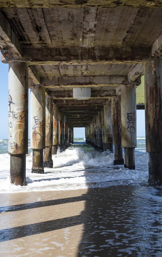 Waves Crashing Beneath the Tranquil Pier Structure Stock Image - Image ...