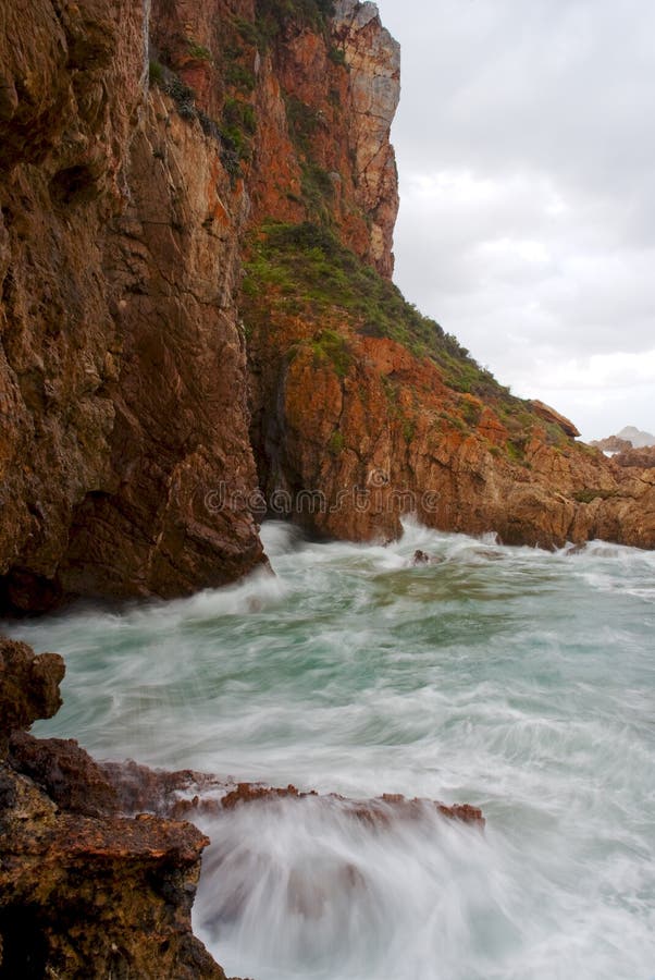 Waves crashing into cliffs stock photo. Image of orange - 45727064