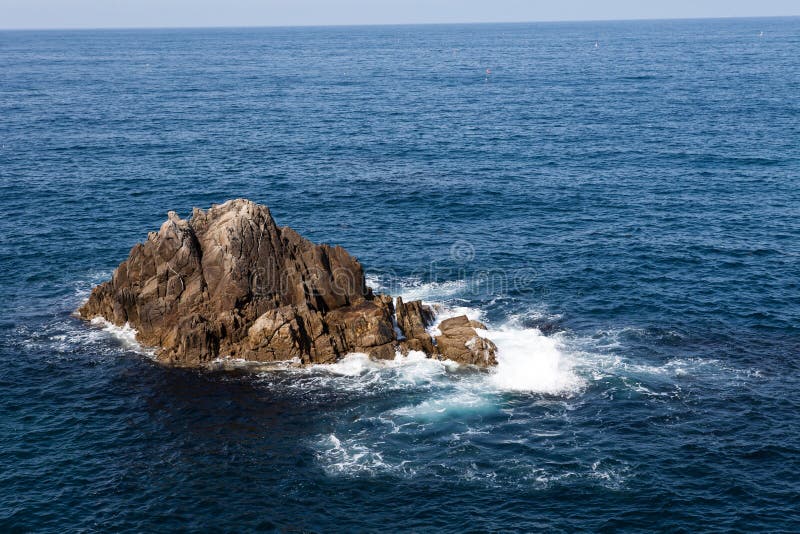 The Waves are Crashing Endlessly on the Rock that Seems To Have Endured ...