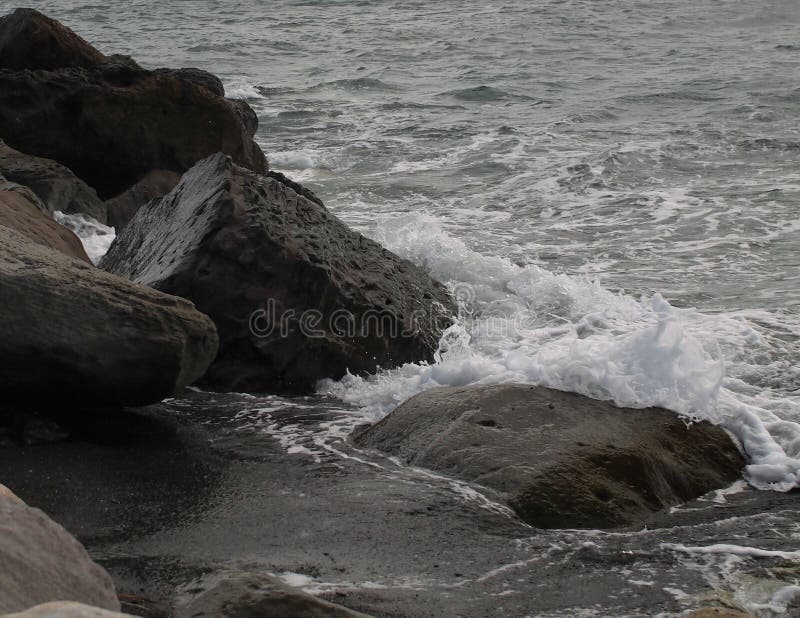 Waves Crashing Onto Rocks on Black Sand Beach Stock Photo - Image of ...