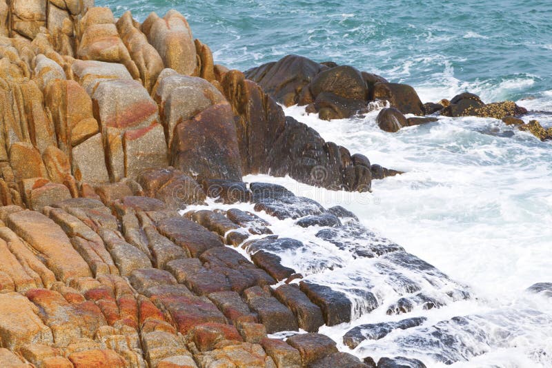 Waves crashing onto rocks stock photo. Image of wave - 70061600