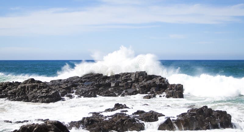 Waves crashing over rocks stock photo. Image of black - 19319368