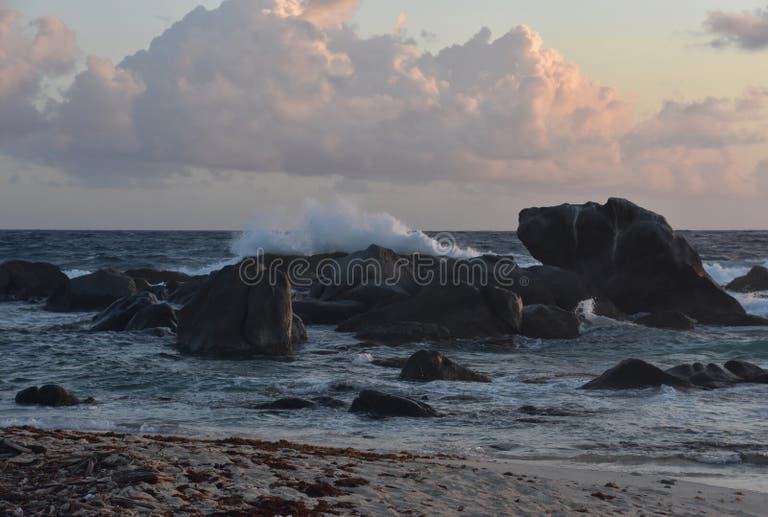 Waves Crashing on Rock Formations Under Pink Clouds Stock Image - Image ...