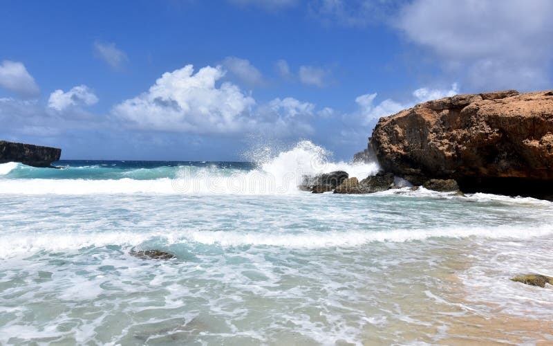 Waves Crashing and Spraying on Rocks on a Remote Beach Stock Image ...