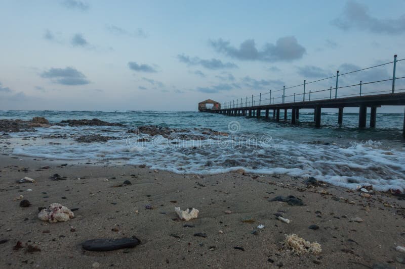 Waves with Foam at the Beach with a Long Jetty at the Sea Stock Image ...