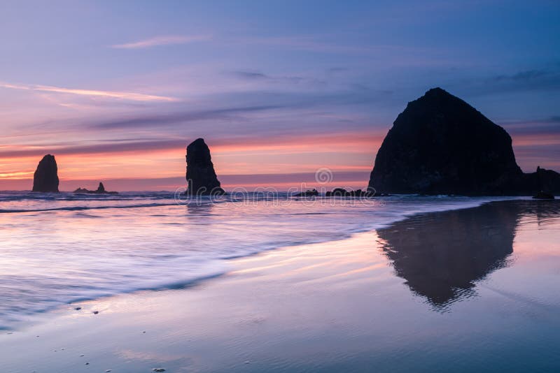 Waves in Front of Cannon Beach Haystack at Sunset Stock Photo - Image ...