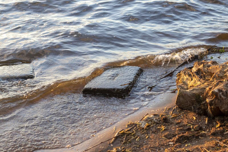 Waves Hitting the Concrete Blocks on the Bank of River. Concept Stock ...