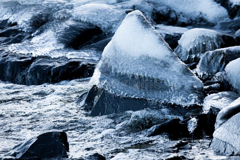 Ice Frozen Over Rocks in Lake Shore Stock Image - Image of dark, icicle ...
