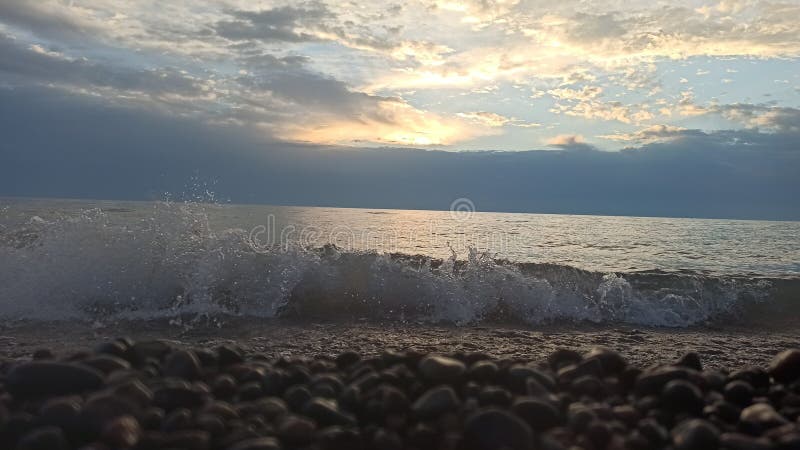 Waves on a Pebble Beach Against the Background of Dawn with Clouds ...