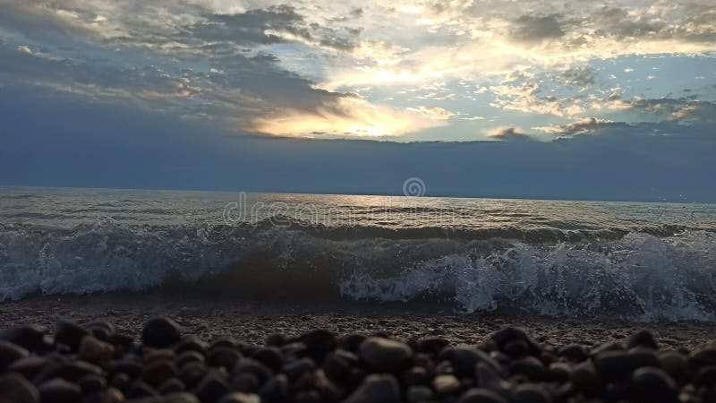 Waves on a Pebble Beach Against the Background of Dawn with Clouds ...