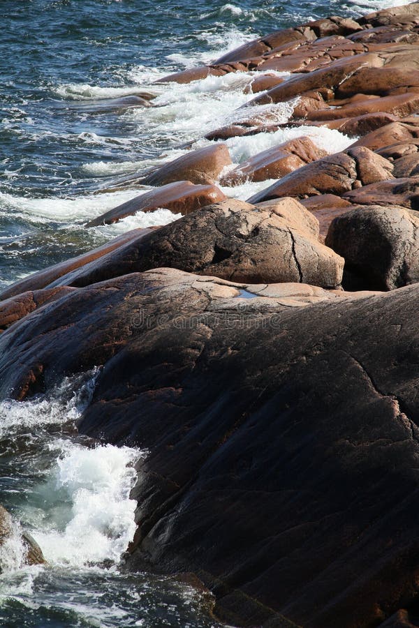 Waves on the Red Shore Rock Stock Image - Image of rock, waves: 142484597