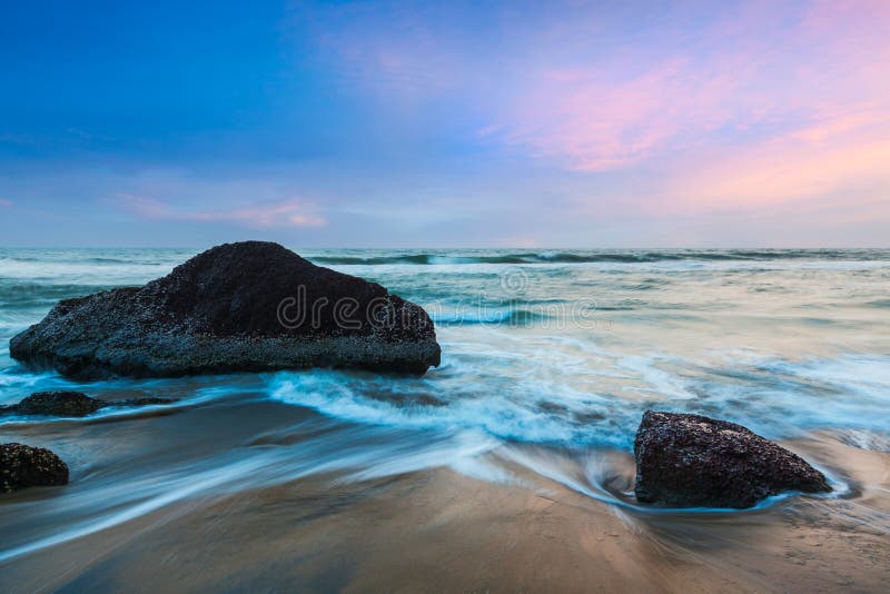 Waves and Rocks on Beach of Sunset Stock Photo - Image of landscape ...