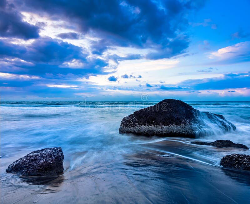 Waves and Rocks on Beach of Sunset Stock Photo - Image of blurred ...
