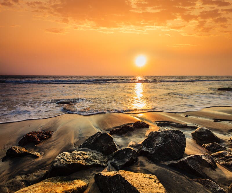Waves and Rocks on Beach of Sunset Stock Photo - Image of rocks, waves ...