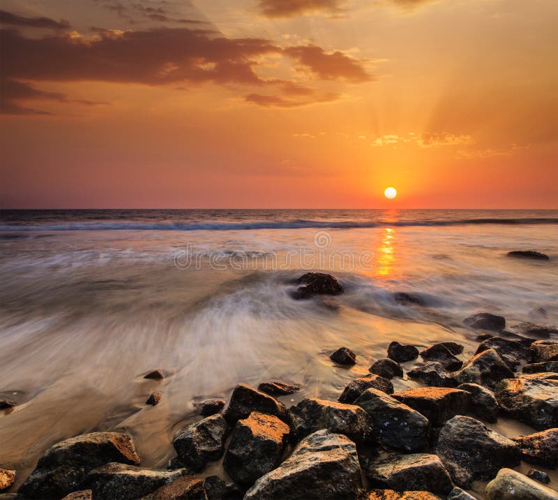 Waves and Rocks on Beach on Sunset Stock Photo - Image of serene, waves ...
