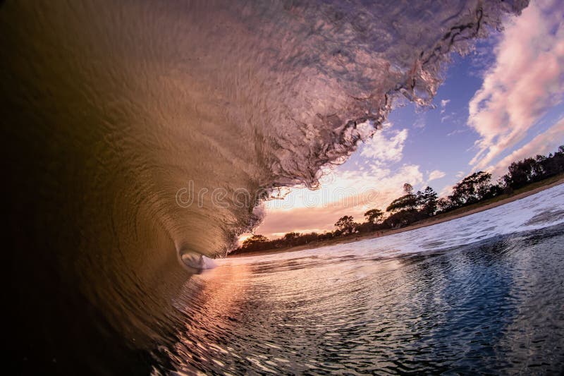 The Waves Roll Around in Barreling at Sunset Stock Photo - Image of ...