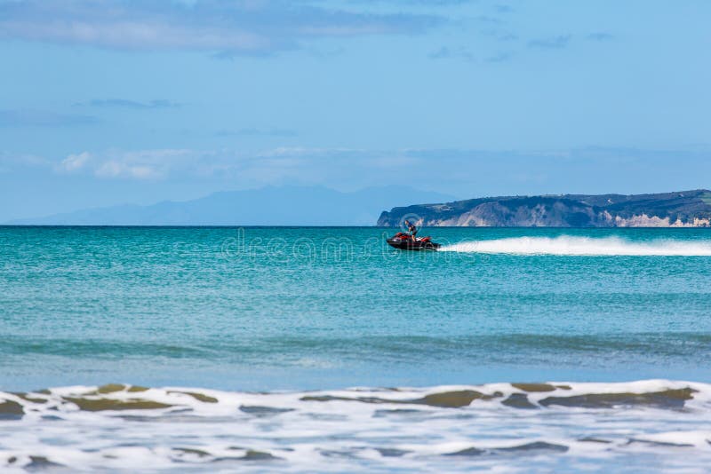 Waves roll into the beach editorial photography. Image of reflections ...
