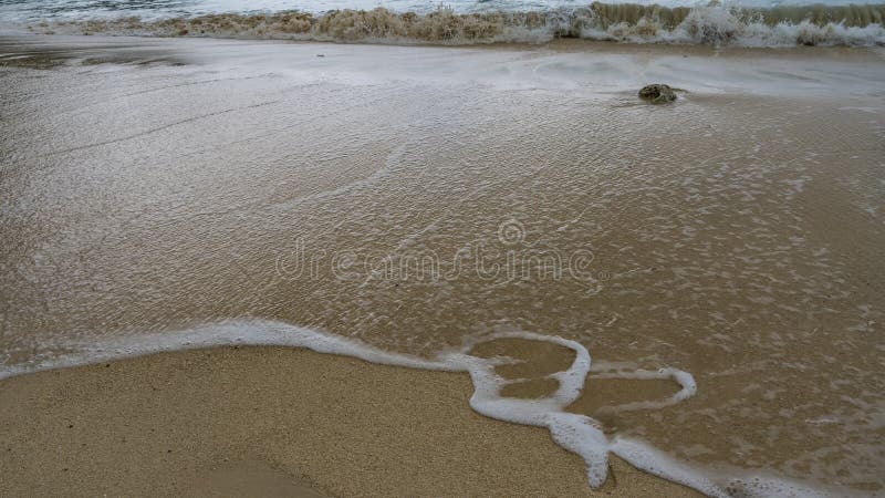 The Waves Roll Onto the Beach and Spread Out. Stock Image - Image of ...