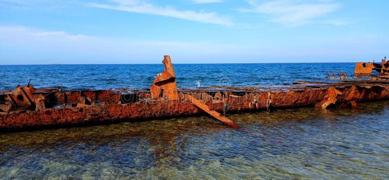 Waves, Rusty Iron, Sand, and Abandoned Beach Stock Photo - Image of ...