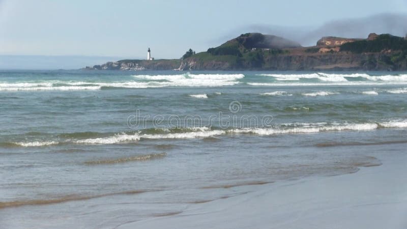 Waves on Sand Beach with Cliffs and Lighthouse Stock Footage - Video of ...