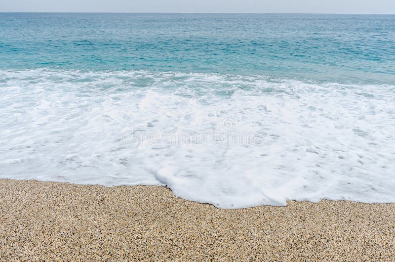 Waves and sand of a beach stock image. Image of clear - 113181553