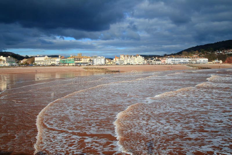 Waves on the sandy beach stock image. Image of sidmouth - 109424571
