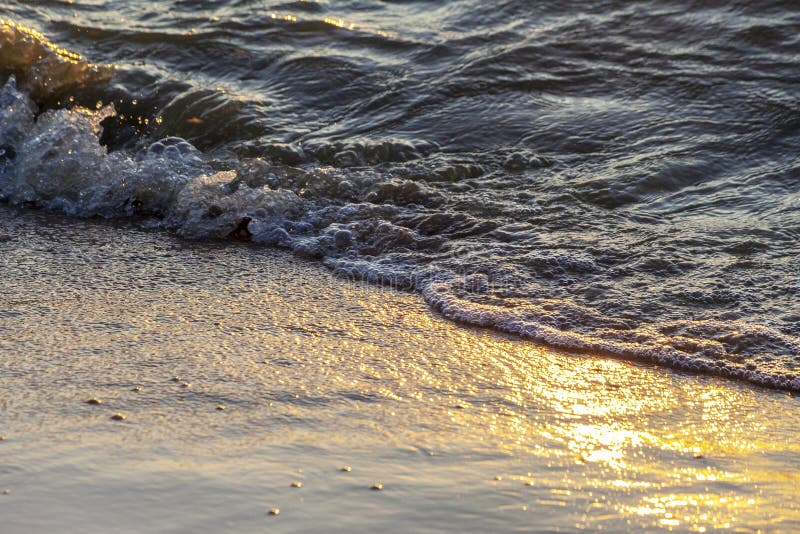 Waves on the Sandy Shore of a Large River. the Rays of Light are ...
