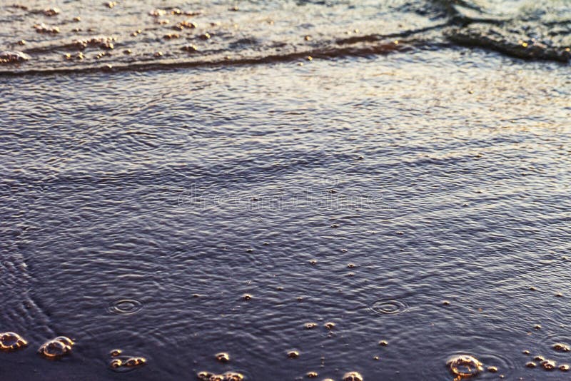Waves on the Sandy Shore of a Large River. the Rays of Light are ...