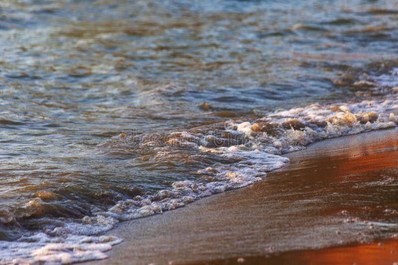 Waves on the Sandy Shore of a Large River. the Rays of Light are ...