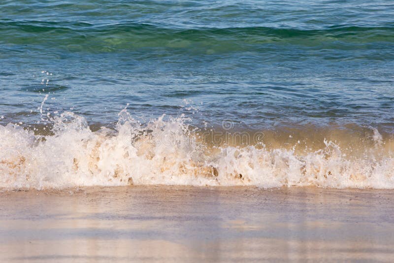 Waves spashing on to sand stock photo. Image of green - 95831764