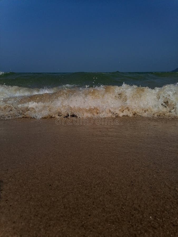 The Waves Splash Beautifully on the Sea Sandy Shore. White Foam from ...