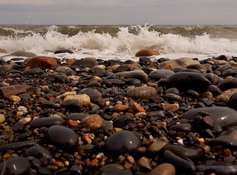 Waves Splashing on a Pebbled Shore Stock Photo - Image of scenic, wash ...
