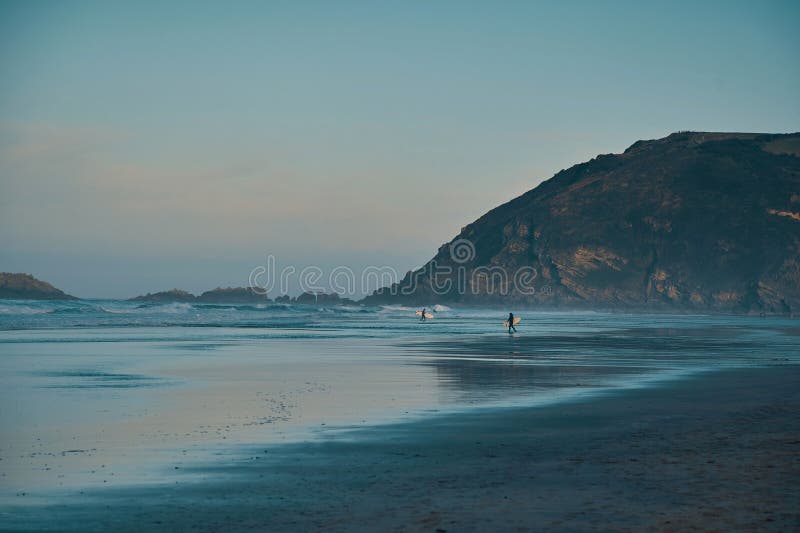 Waves and Surfers on a Flat Beach Stock Photo - Image of waiting ...