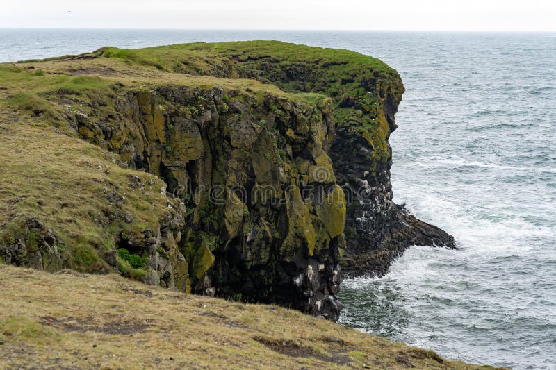 Waves Washing Against Black Basalt Cliffs at Arnarstapi Cliffs in ...