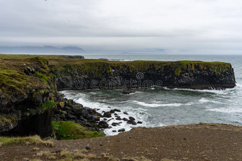 Waves Washing Against Black Basalt Cliffs at Arnarstapi Cliffs in ...